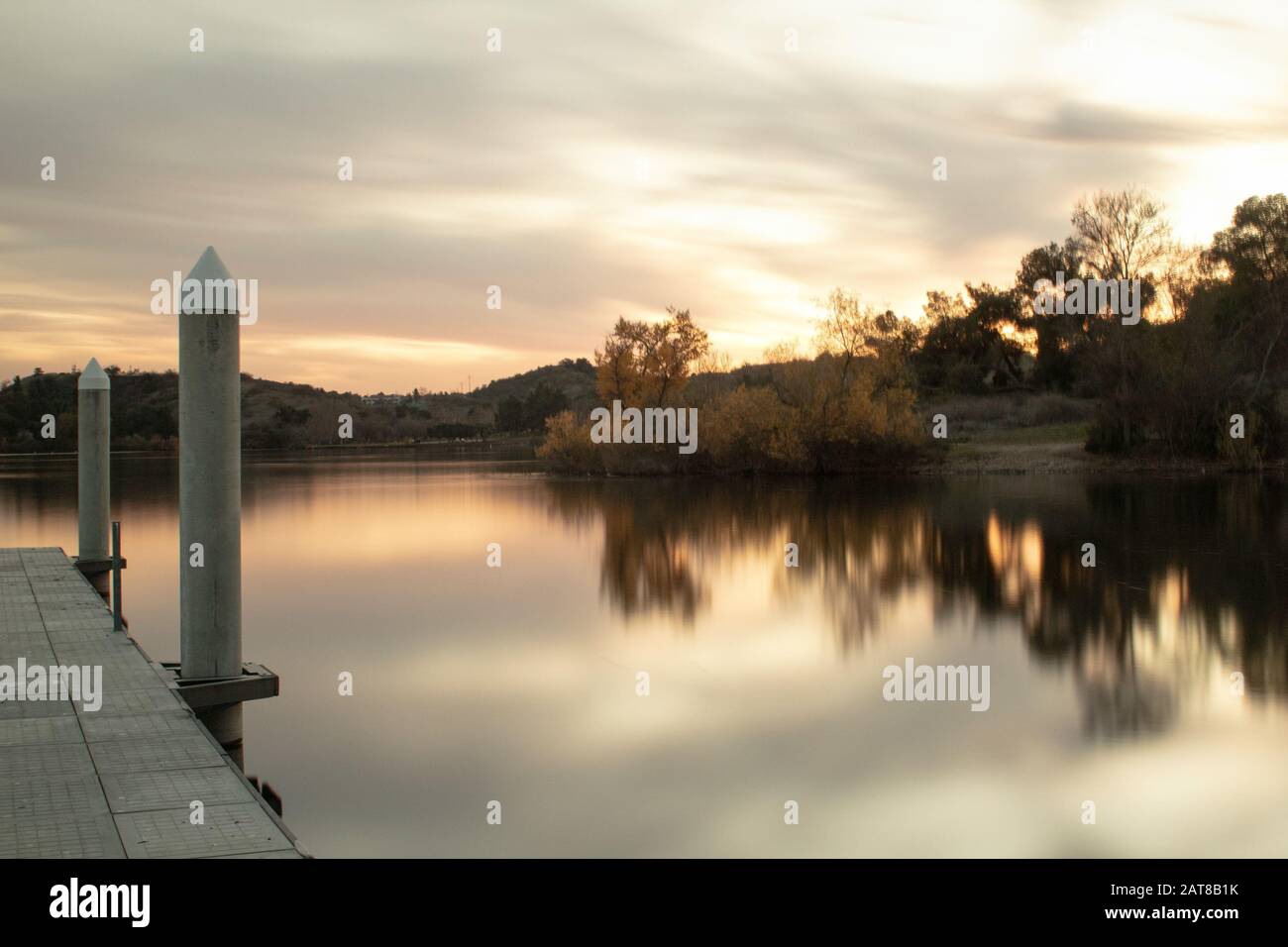 shot of a stone bridge with a couple of stone columns on a small lake ...