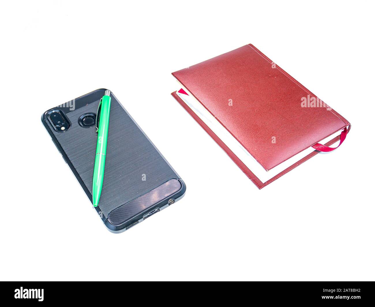 Weekly and mobile phone on a white background. Business. Work. Place ...