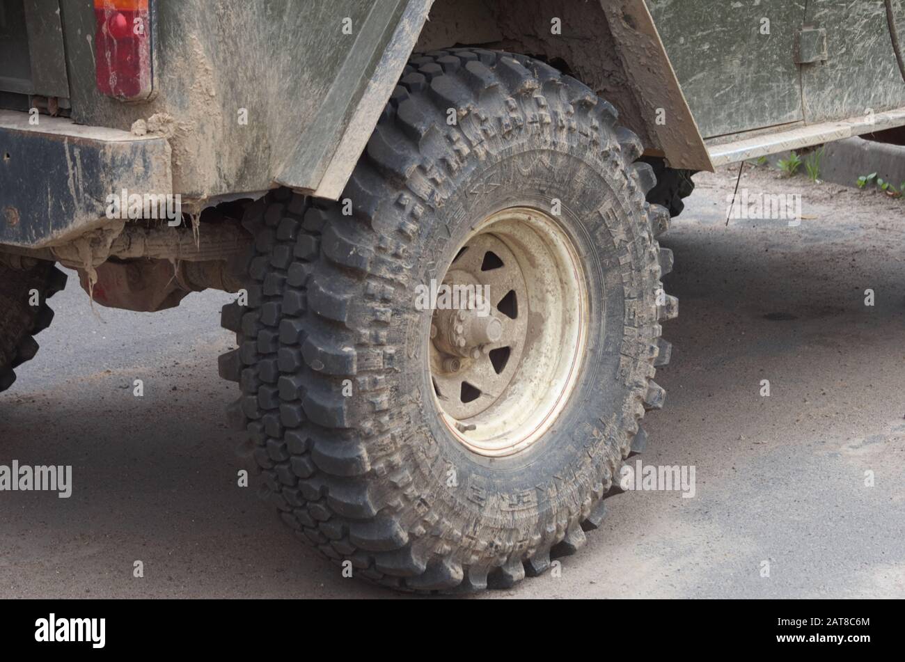 dirty wheels and suspension of an old SUV parked Stock Photo - Alamy