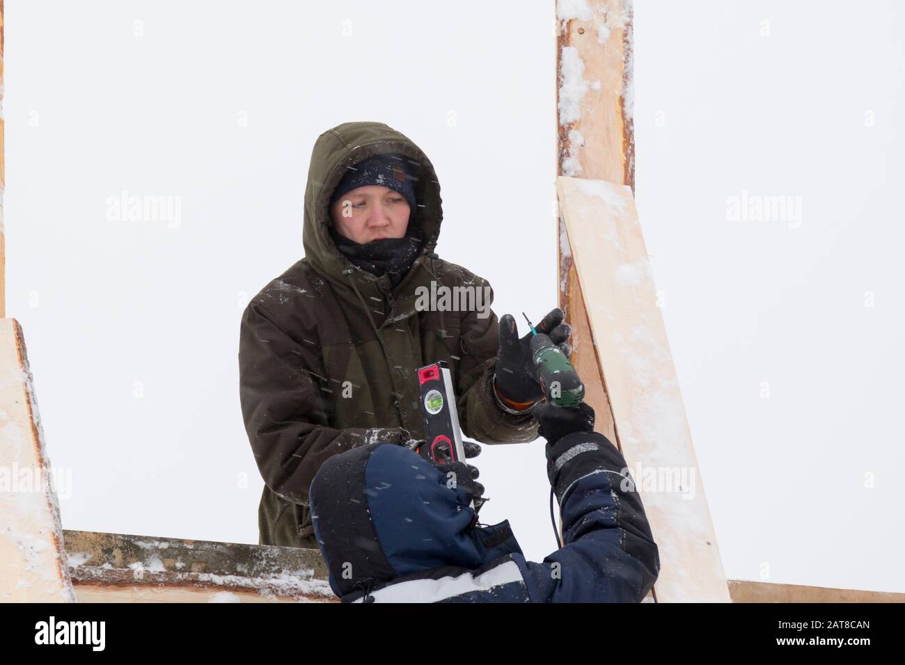 Two workers in overalls at a construction site Stock Photo - Alamy