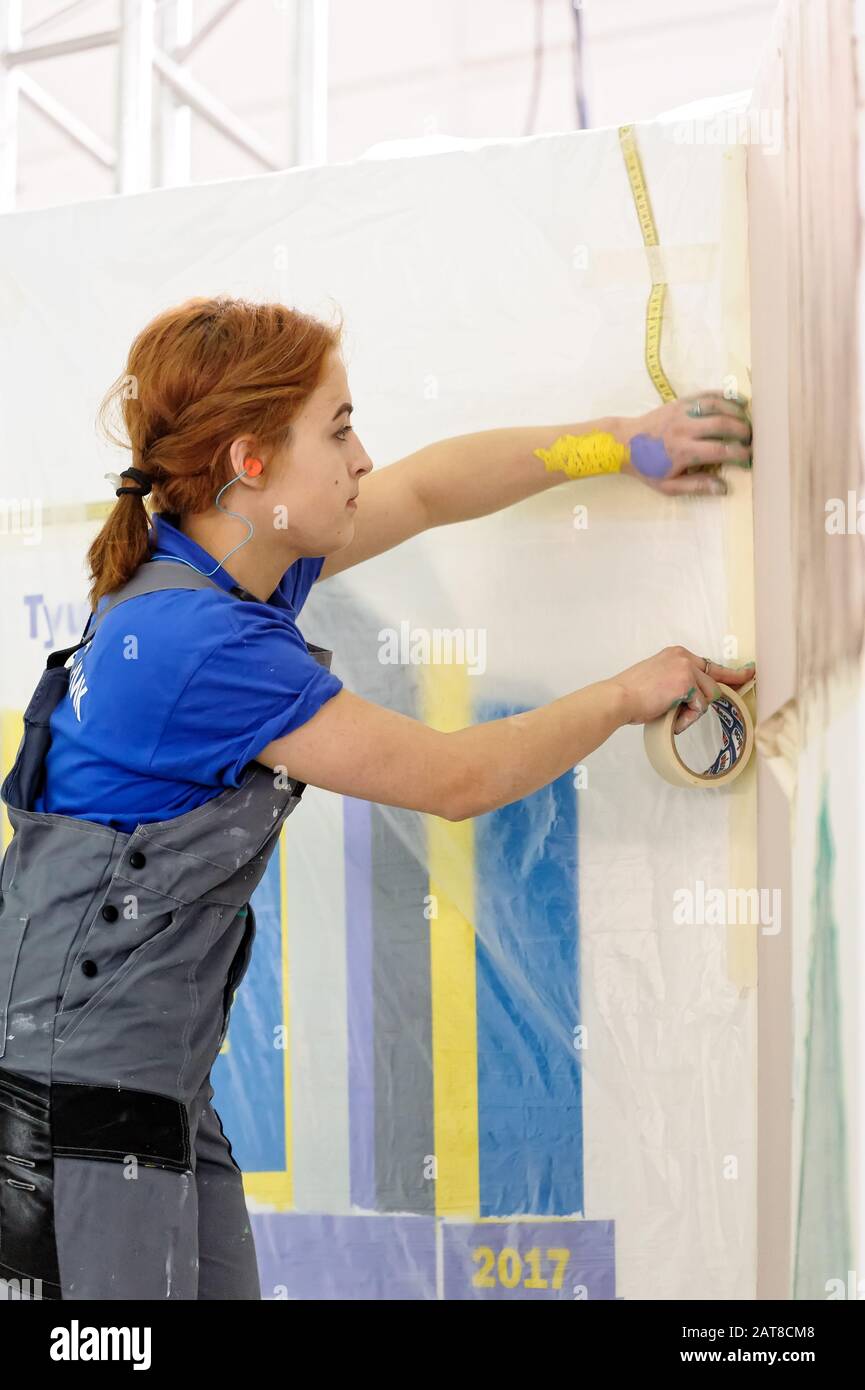 Female painter decorates wall, performing task Stock Photo - Alamy