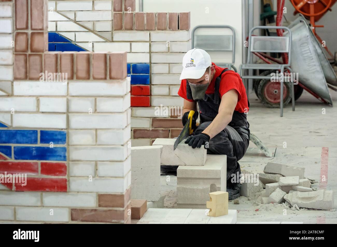 Young bricklayer performs a task of competition Stock Photo - Alamy