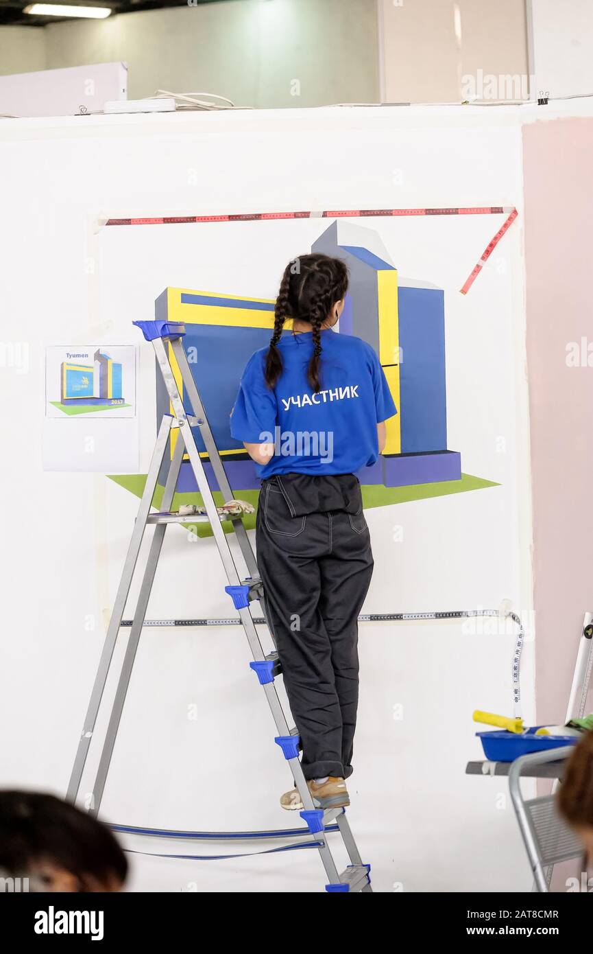 Female painter decorates wall, performing task Stock Photo - Alamy