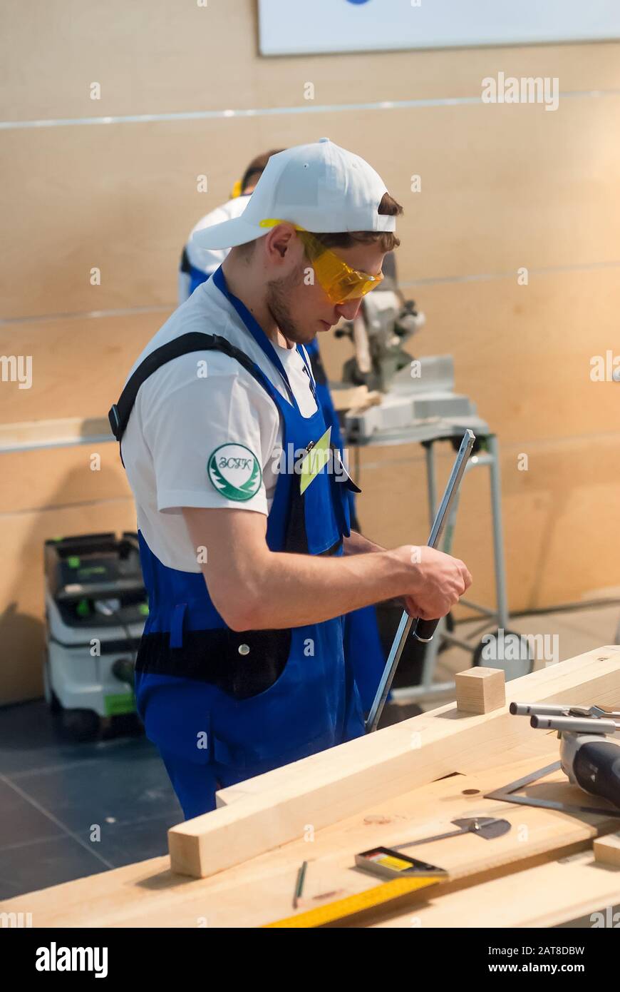 Young carpenter performs task of competition Stock Photo - Alamy