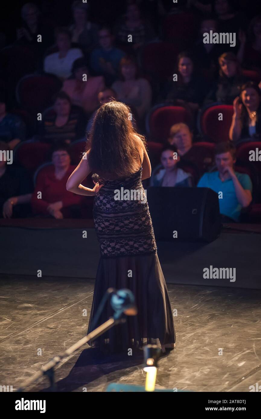 Beautiful female singer singing a song on stage Stock Photo - Alamy