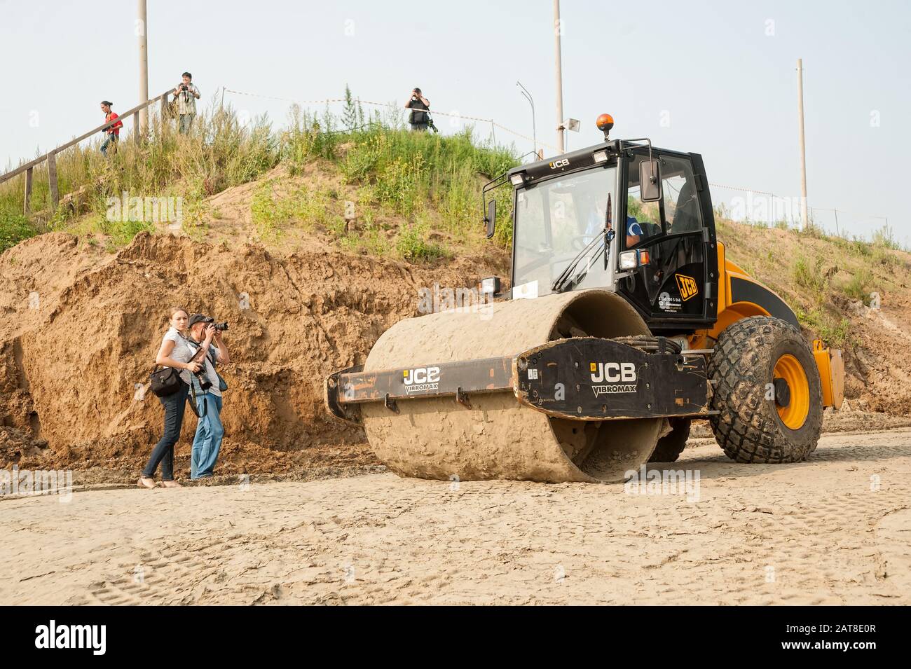 Road roller compressing sand to highway Stock Photo - Alamy