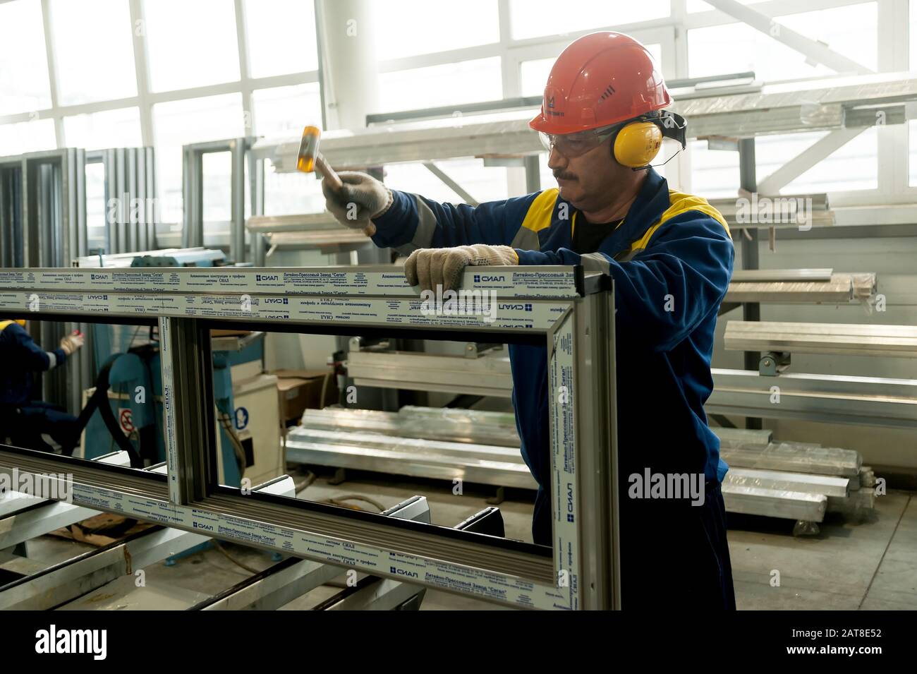 Worker manufacturing plastic window assembly hi-res stock photography ...