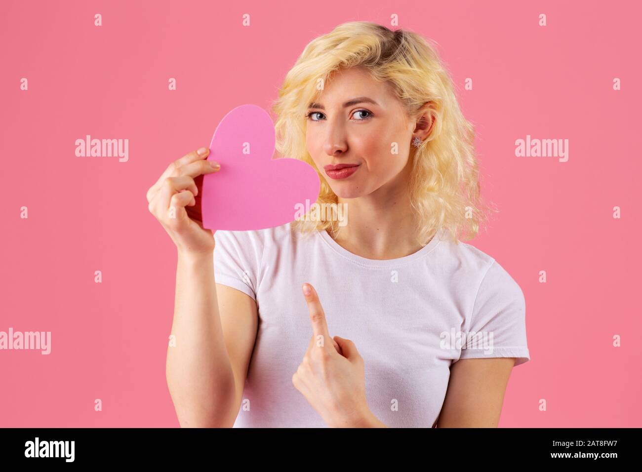 Woman pointing at heart hi-res stock photography and images - Alamy
