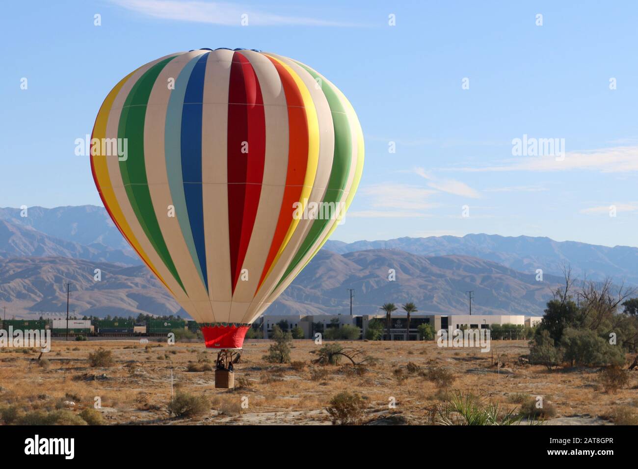 a hot air balloon landing in the desert Stock Photo - Alamy