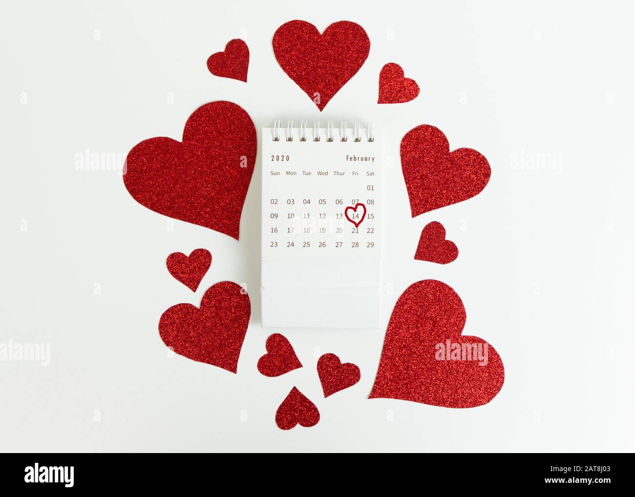 February calendar. Date February 14 is circled by a heart. Surrounded ...