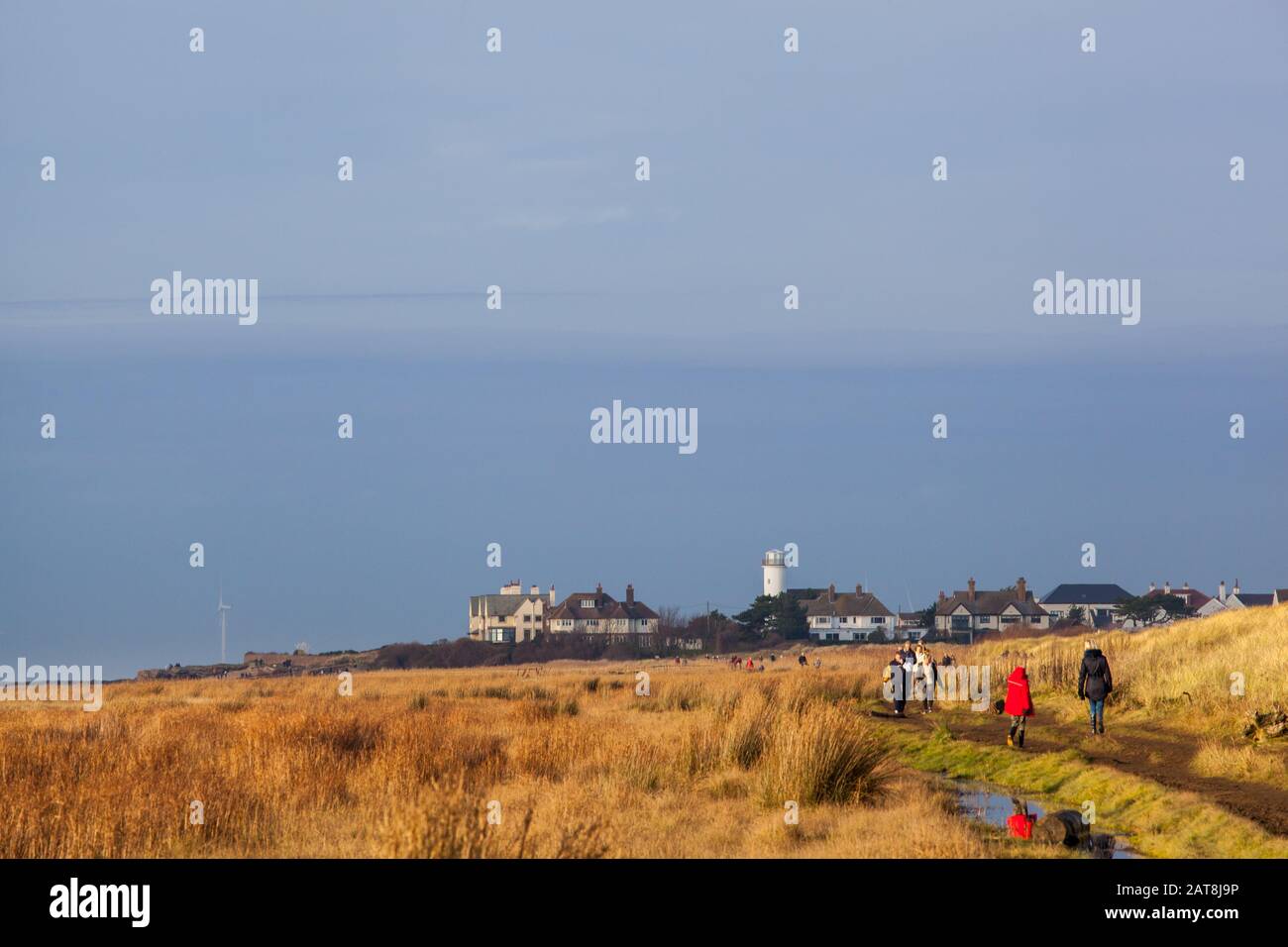 People walking along the coastal path along the river Dee through the ...