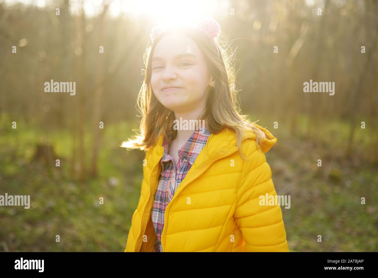 Cute young girl having fun on beautiful spring day. Active family ...