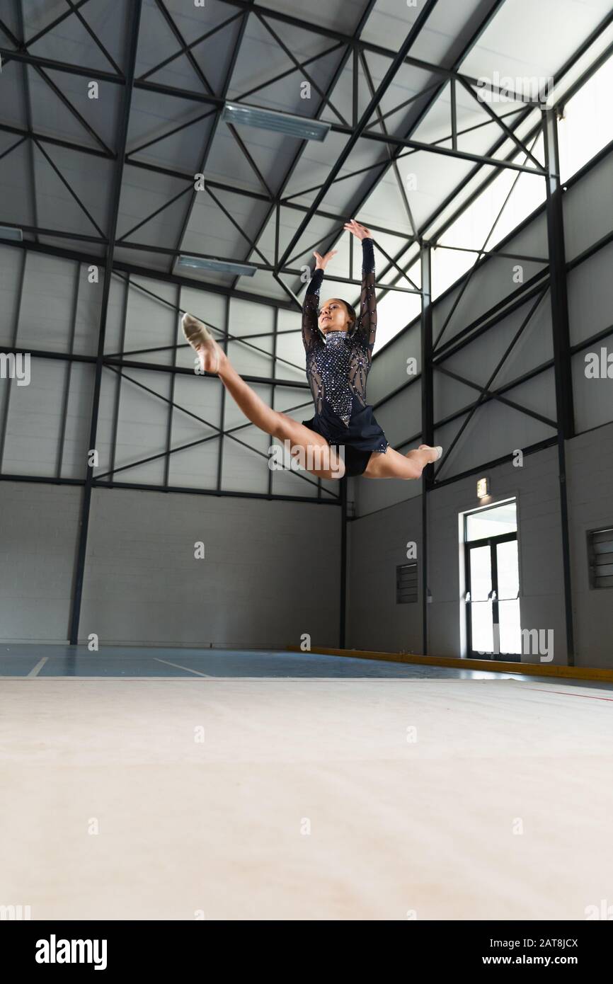 Gymnast jumping at the gym Stock Photo - Alamy
