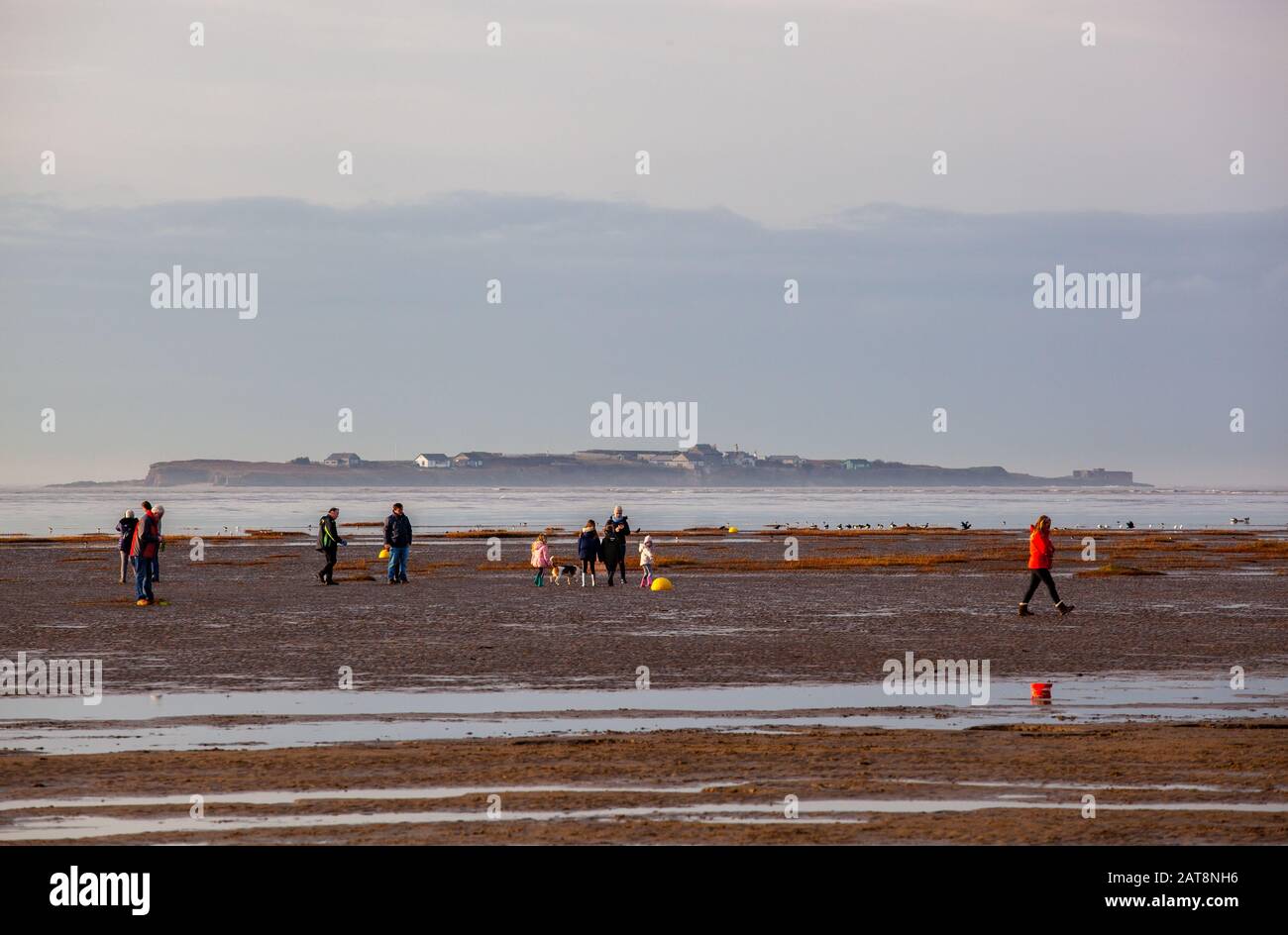 Hilbre Island in the Dee estuary seen from the beach at West Kirby on the Wirral Peninsula Stock ...