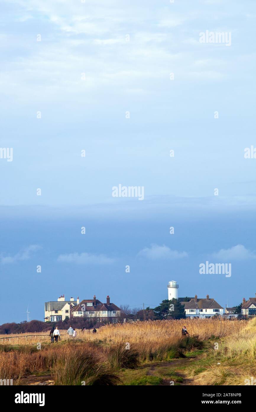 People walking along the coastal path along the river Dee through the ...