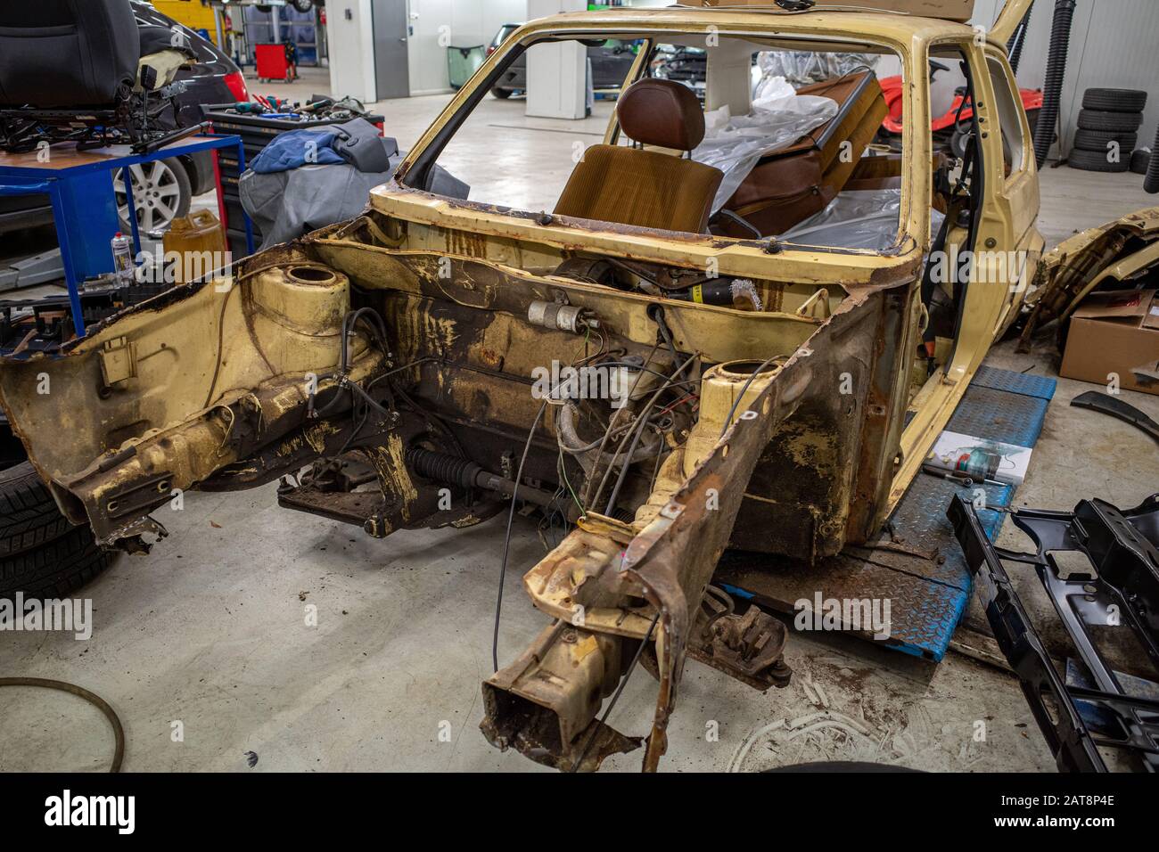 in a garage there is a disassembled old car wreck to be restored Stock ...