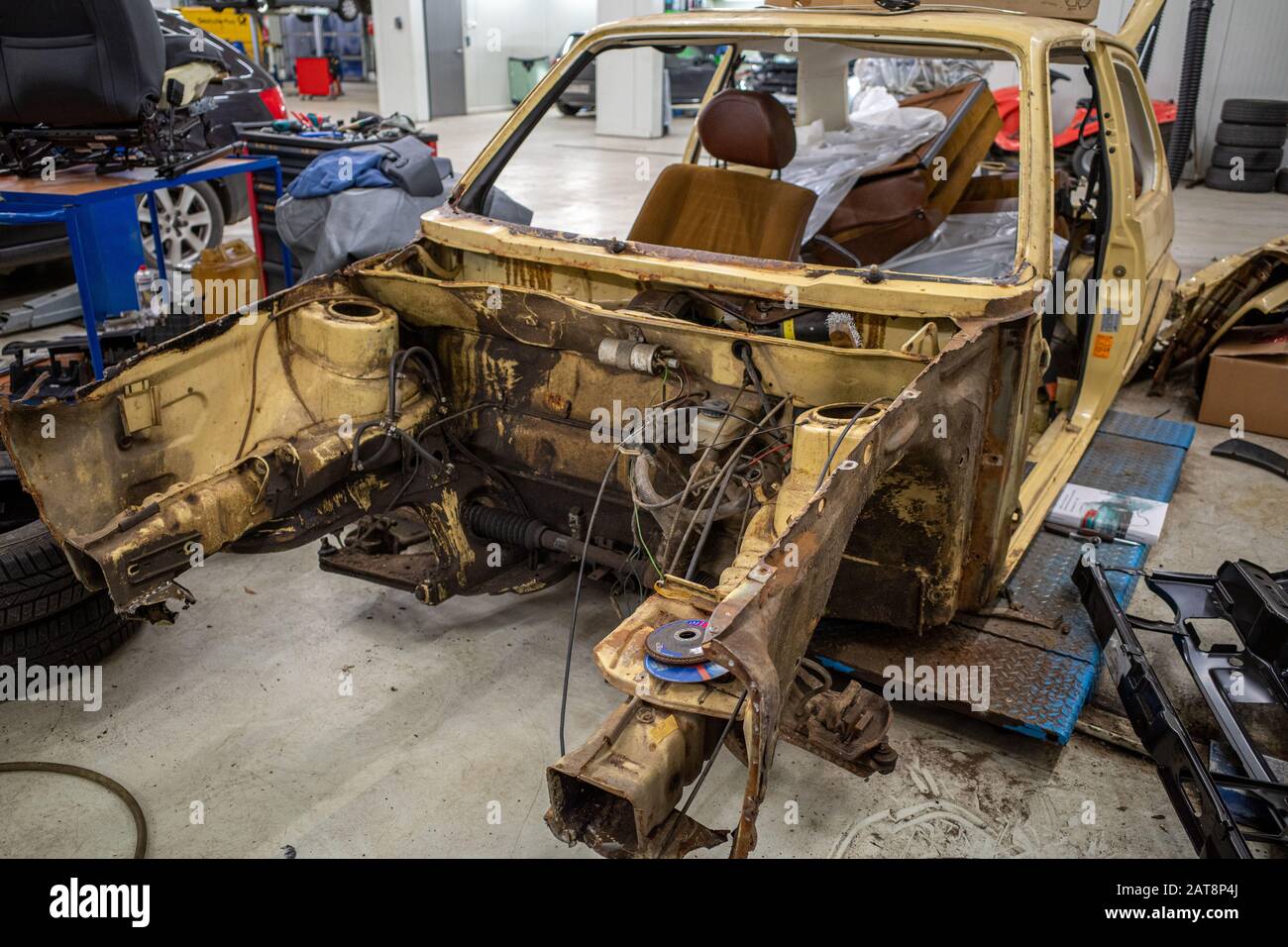 in a garage there is a disassembled old car wreck to be restored Stock ...
