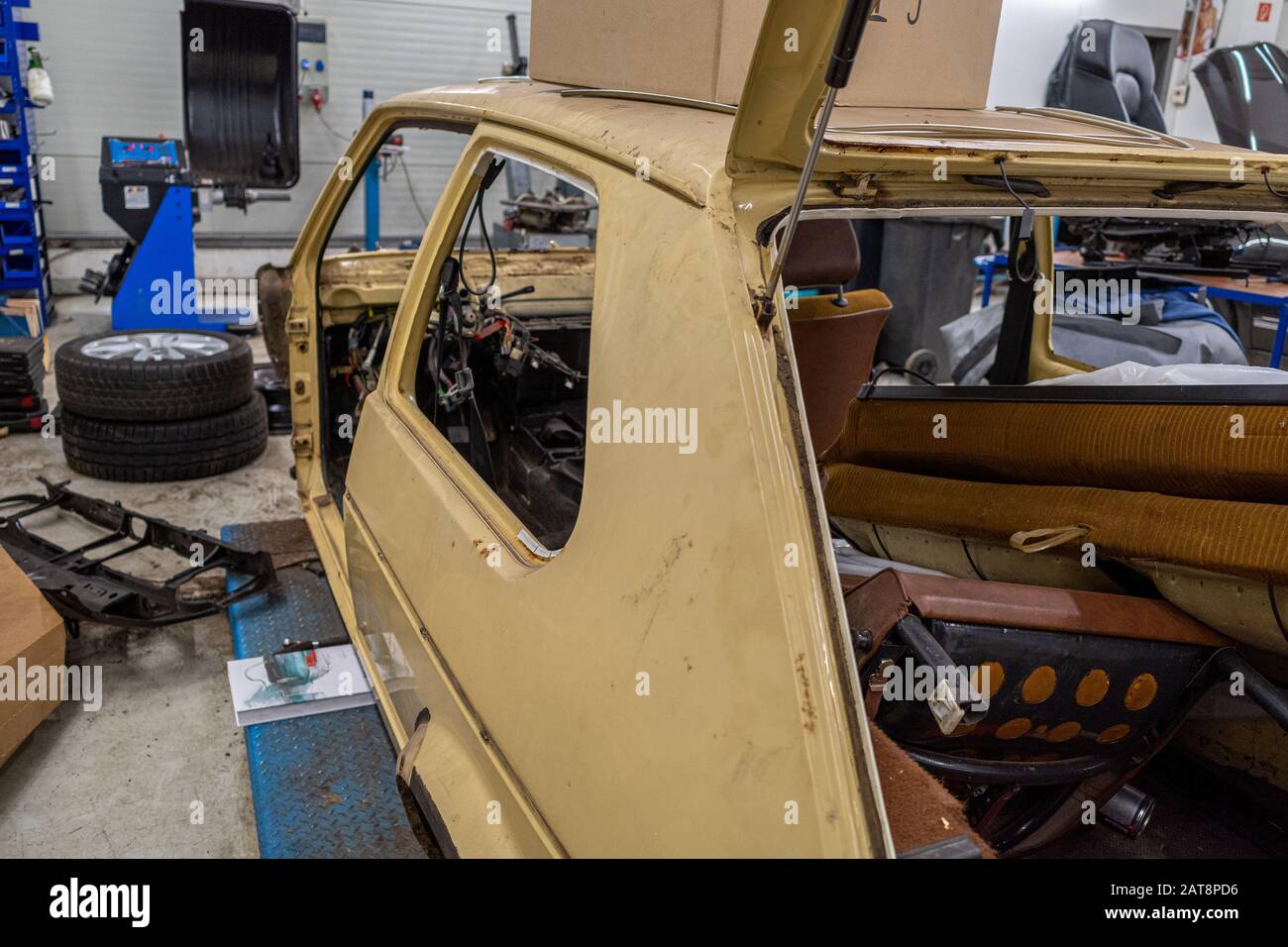 in a garage there is a disassembled old car wreck to be restored Stock ...