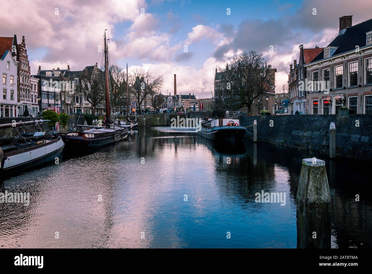 Photo of the historic Delfshaven with beautiful colored clouds in ...