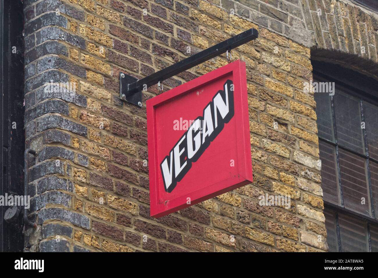 Vegan sign on a brick wall Stock Photo - Alamy