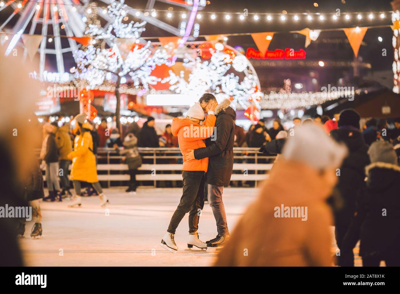 Beautiful Couple Ice Skating In City Centre. Young couple skating at a ...