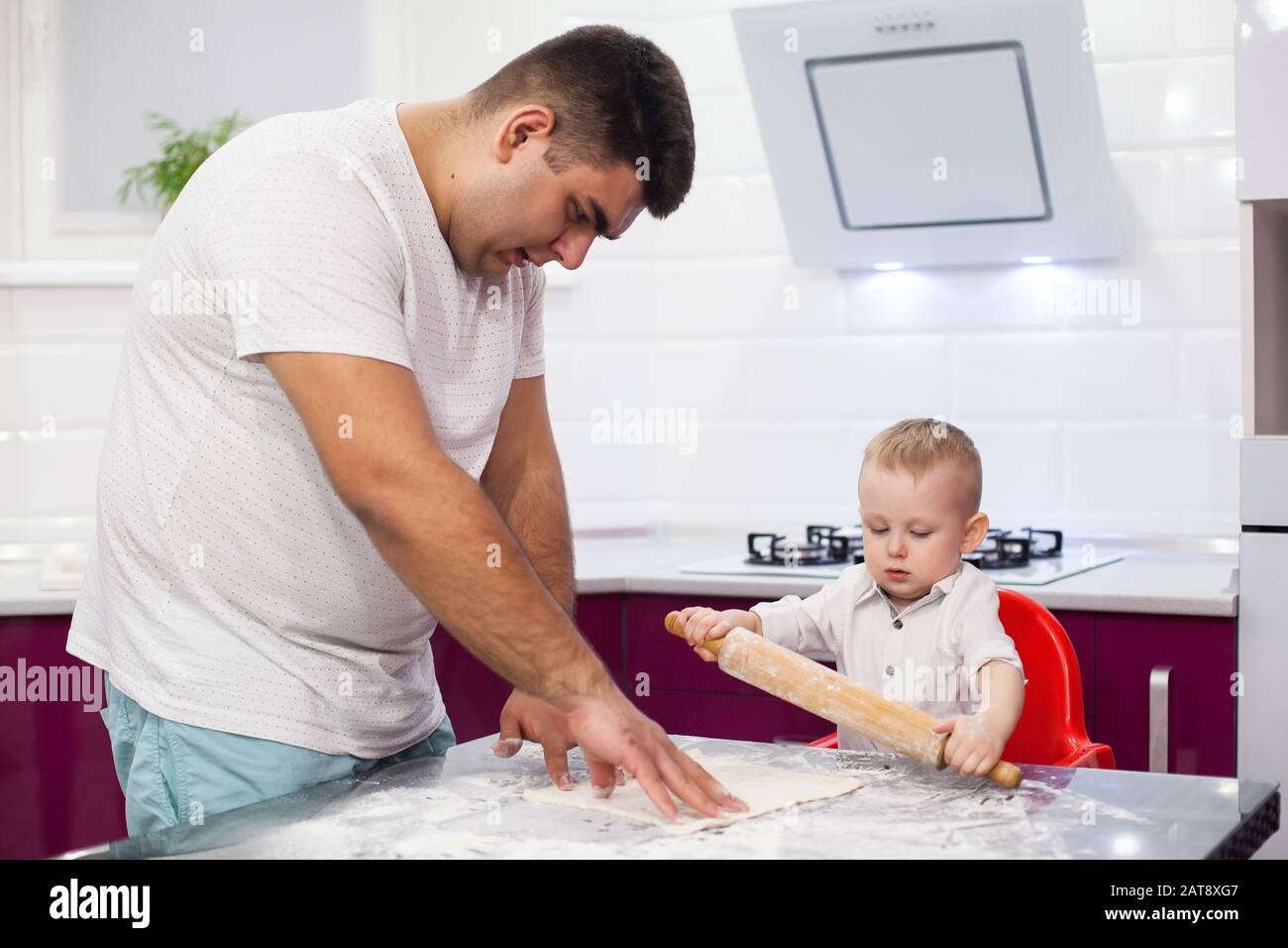 Kid rolls out the pizza dough. Happy family in kitchen Stock Photo - Alamy Kid rolls out the pizza dough. Happy family in kitchen Stock Photo - Alamy