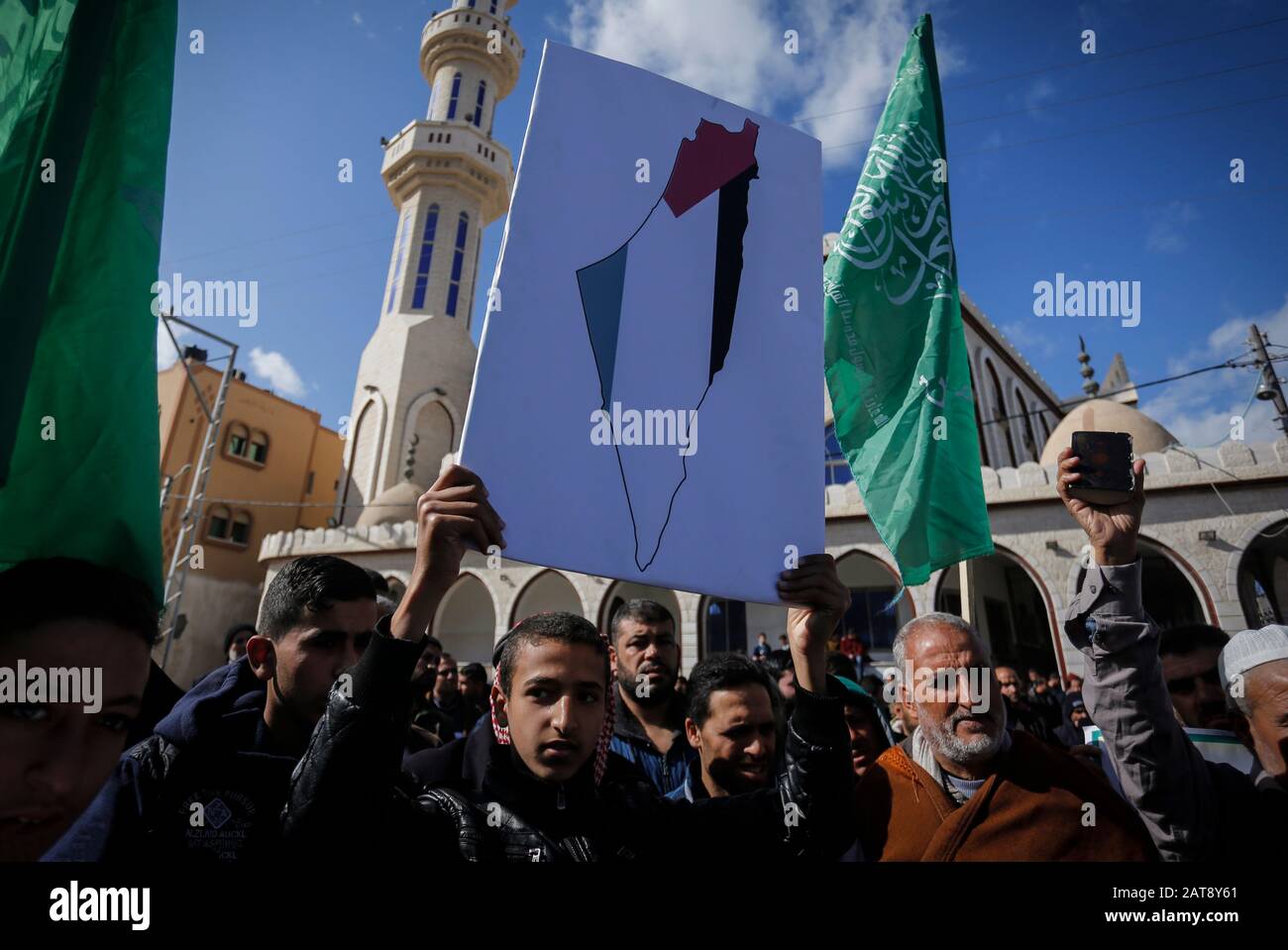 A Palestinian protester holds a map of Palestine during a protest ...