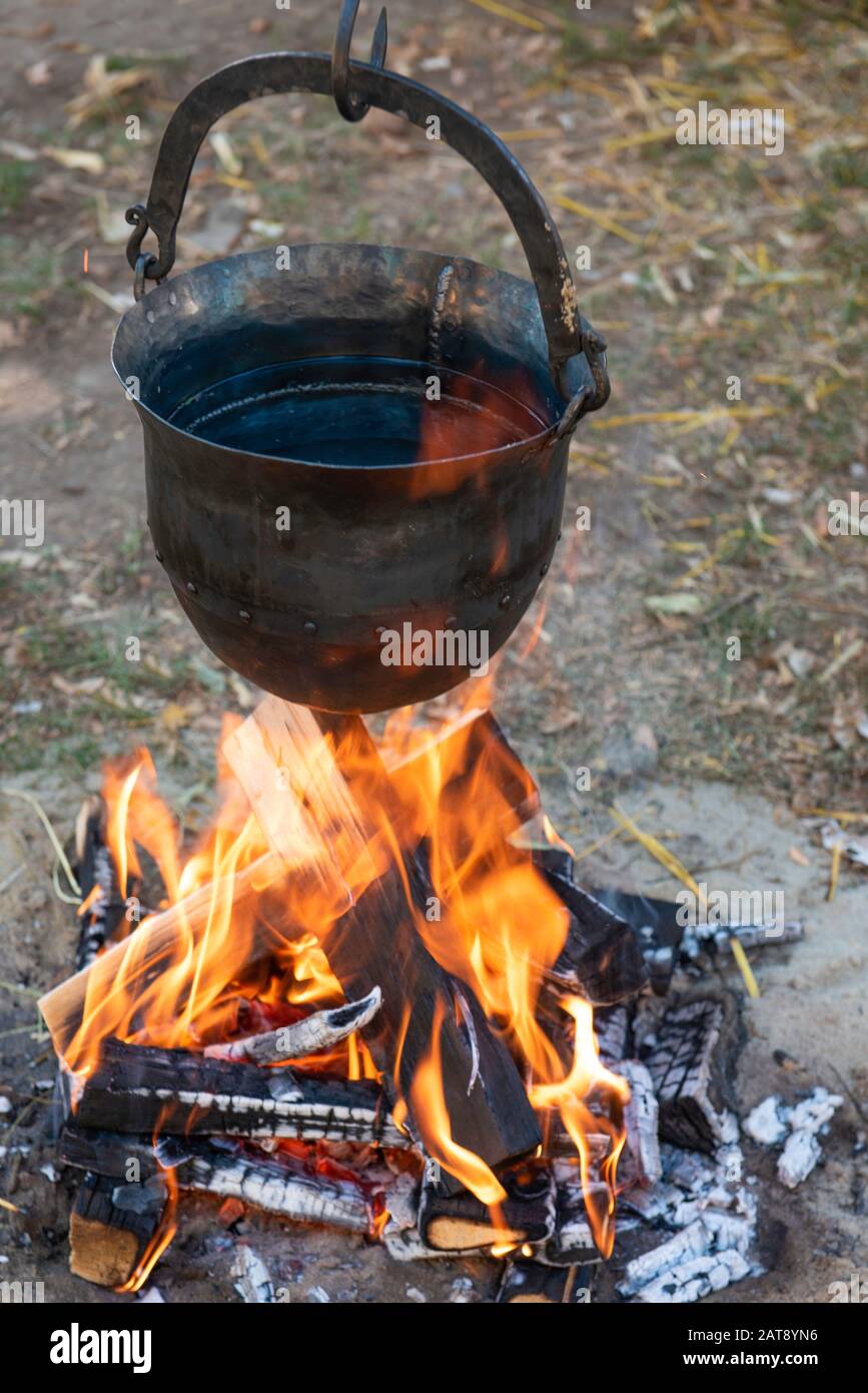 Cooking outdoor in a old tin kettle from middle age Stock Photo - Alamy