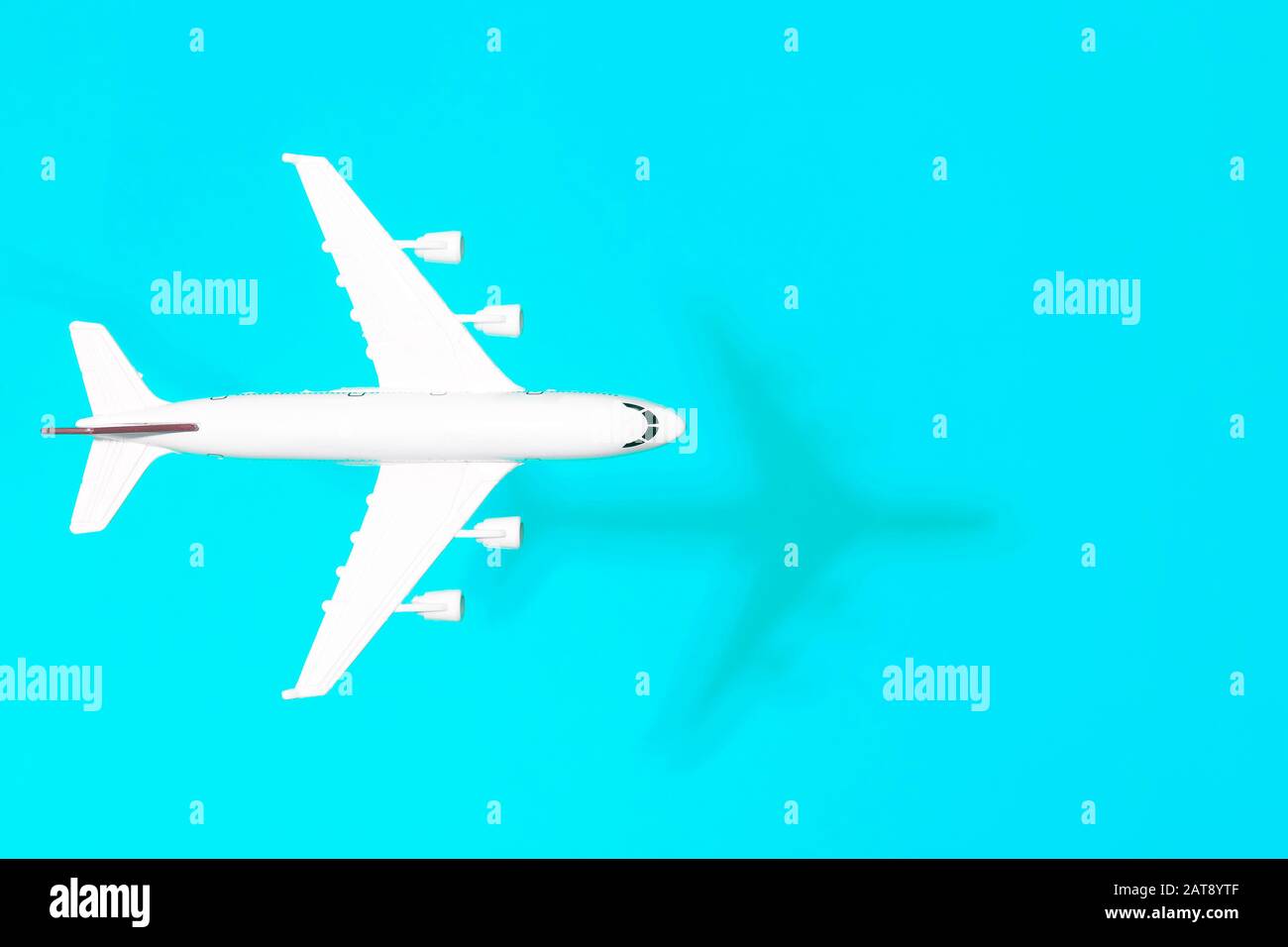 Travel minimal background. Model airplane in flight on an empty colored ...