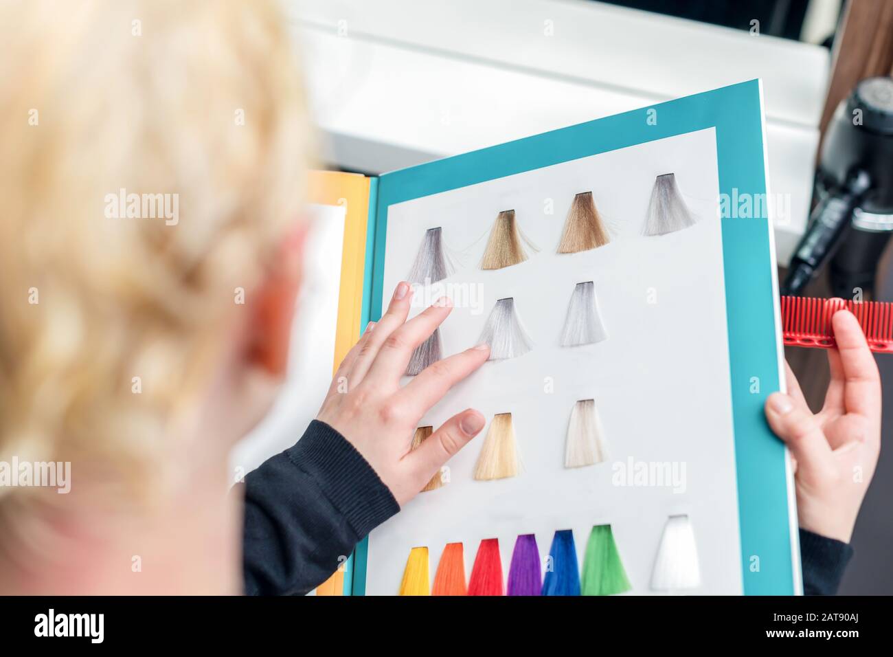 Female selecting hair color from color palette in beauty salon, close ...