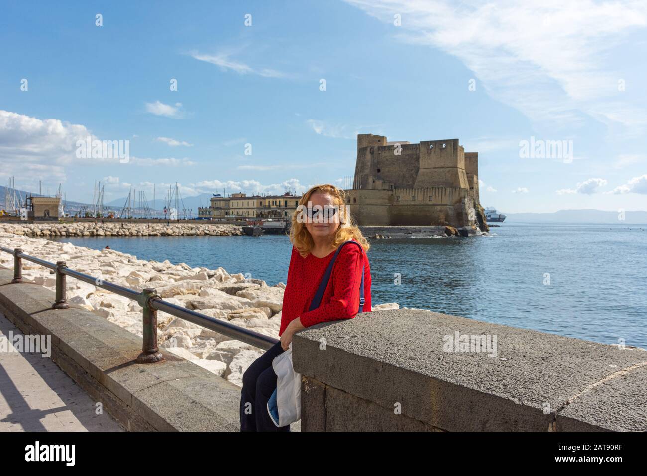 Italy, Naples, blonde tourist posing on the waterfront Stock Photo - Alamy