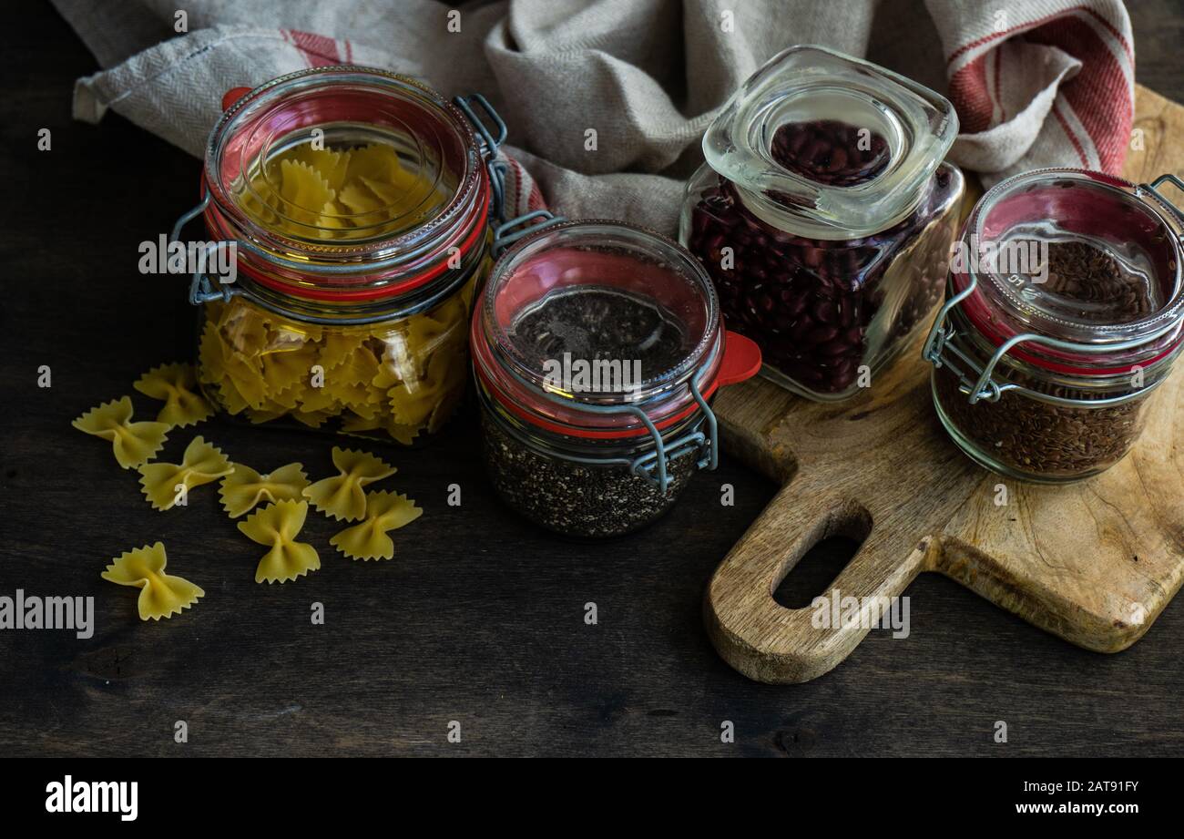 Cooking food concept with pasta, seeds and beans on wooden background ...