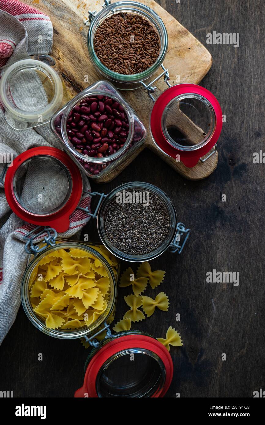 Cooking food concept with pasta, seeds and beans on wooden background ...