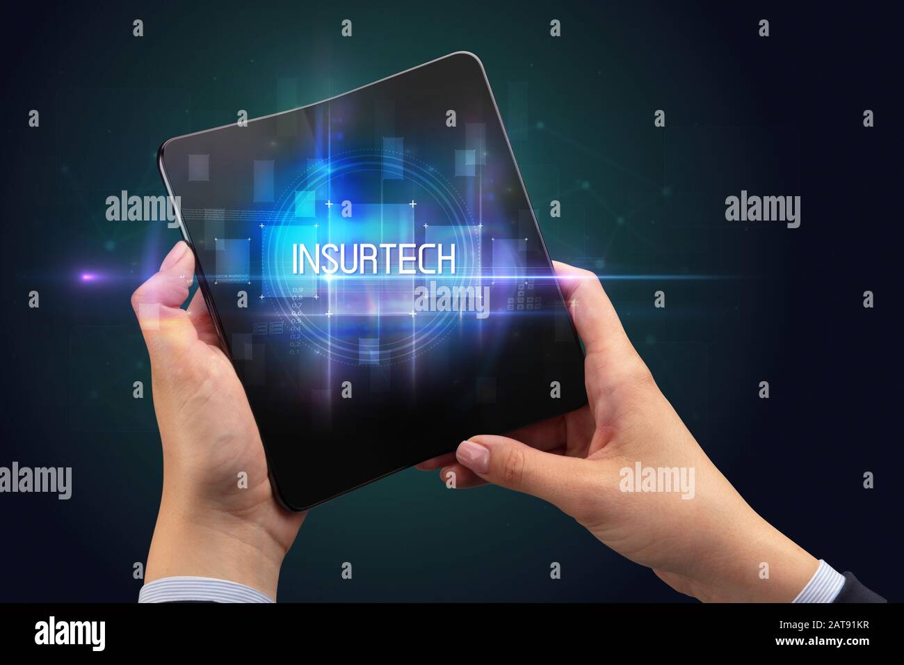 Businessman holding a foldable smartphone with INSURTECH inscription ...