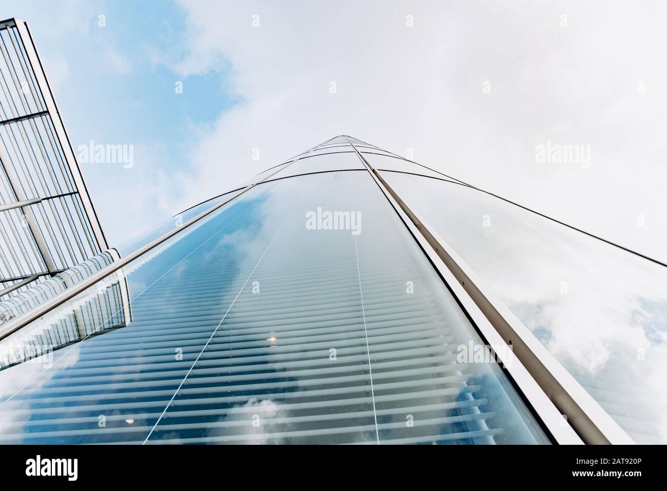 Reflection of the sky on a skyscraper. View of skyscrapers from below ...