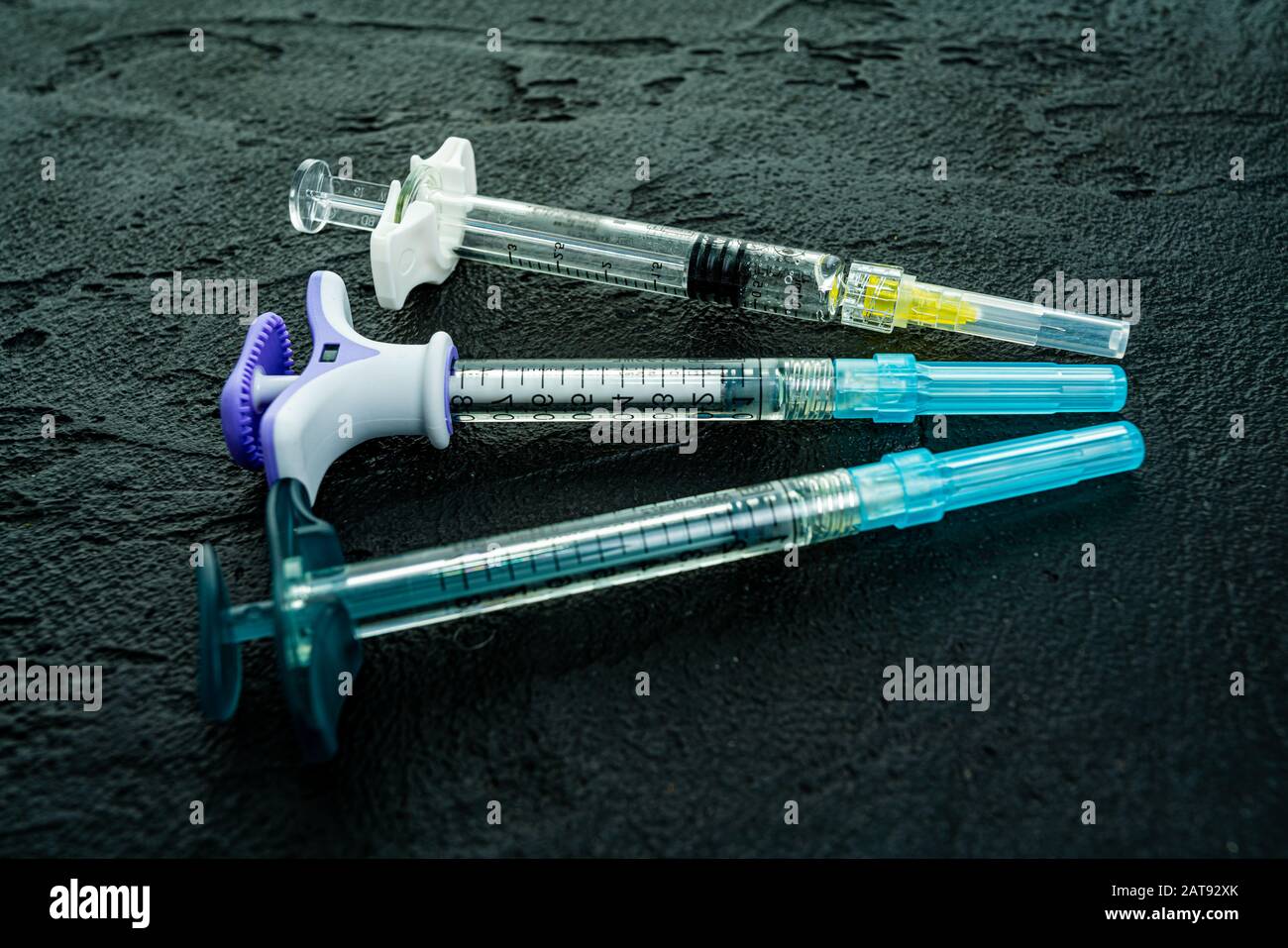 Medical injection syringes with solution on black background Stock ...