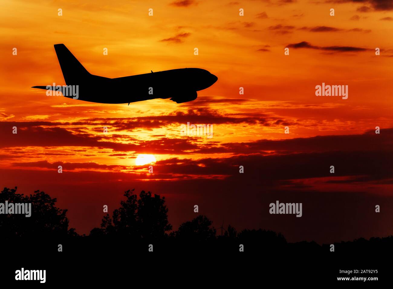 Airplane In The Sky At Sunset. Travel background with passenger plane ...