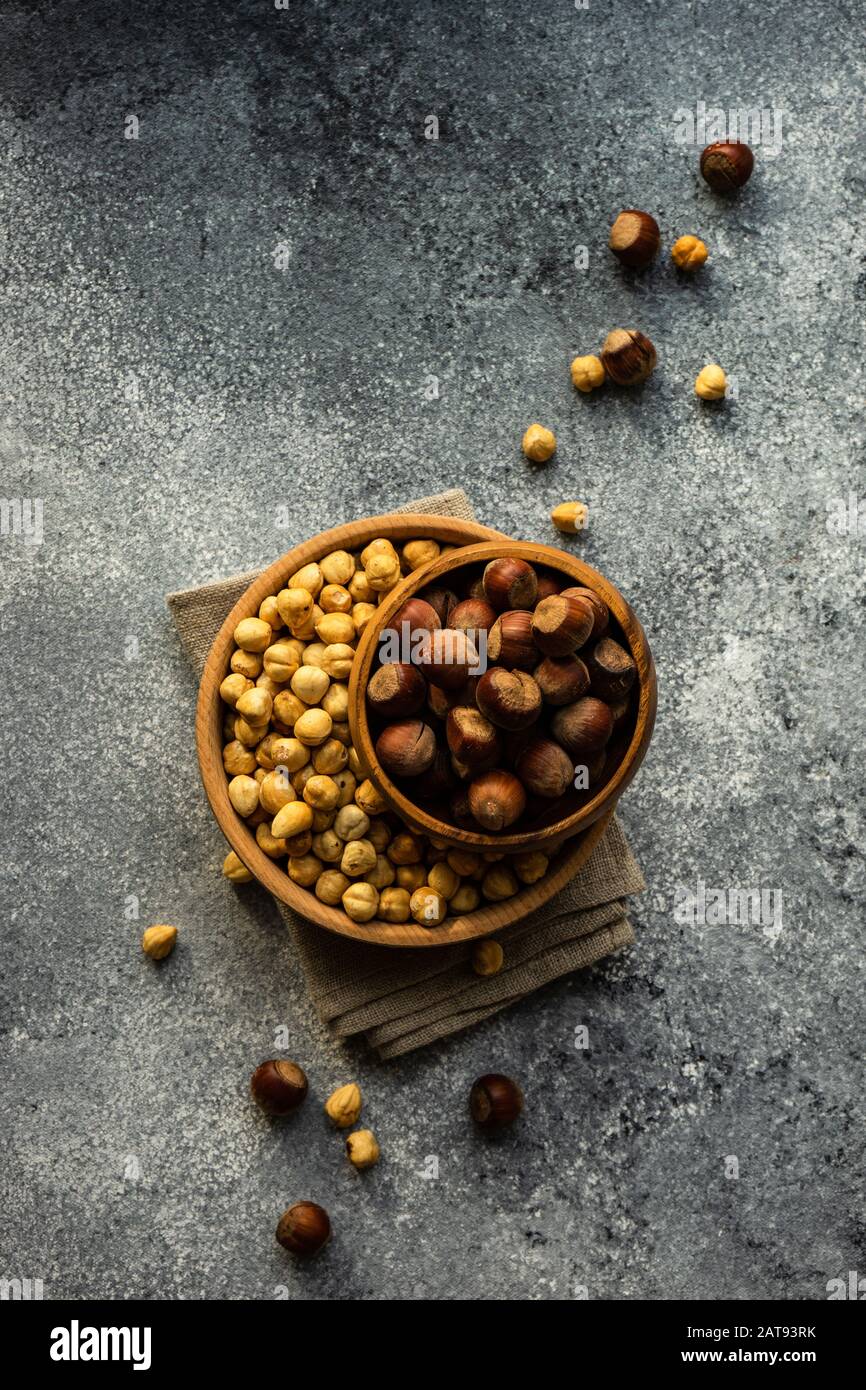 Different types of hazelnuts on dark wooden background with copyspace ...