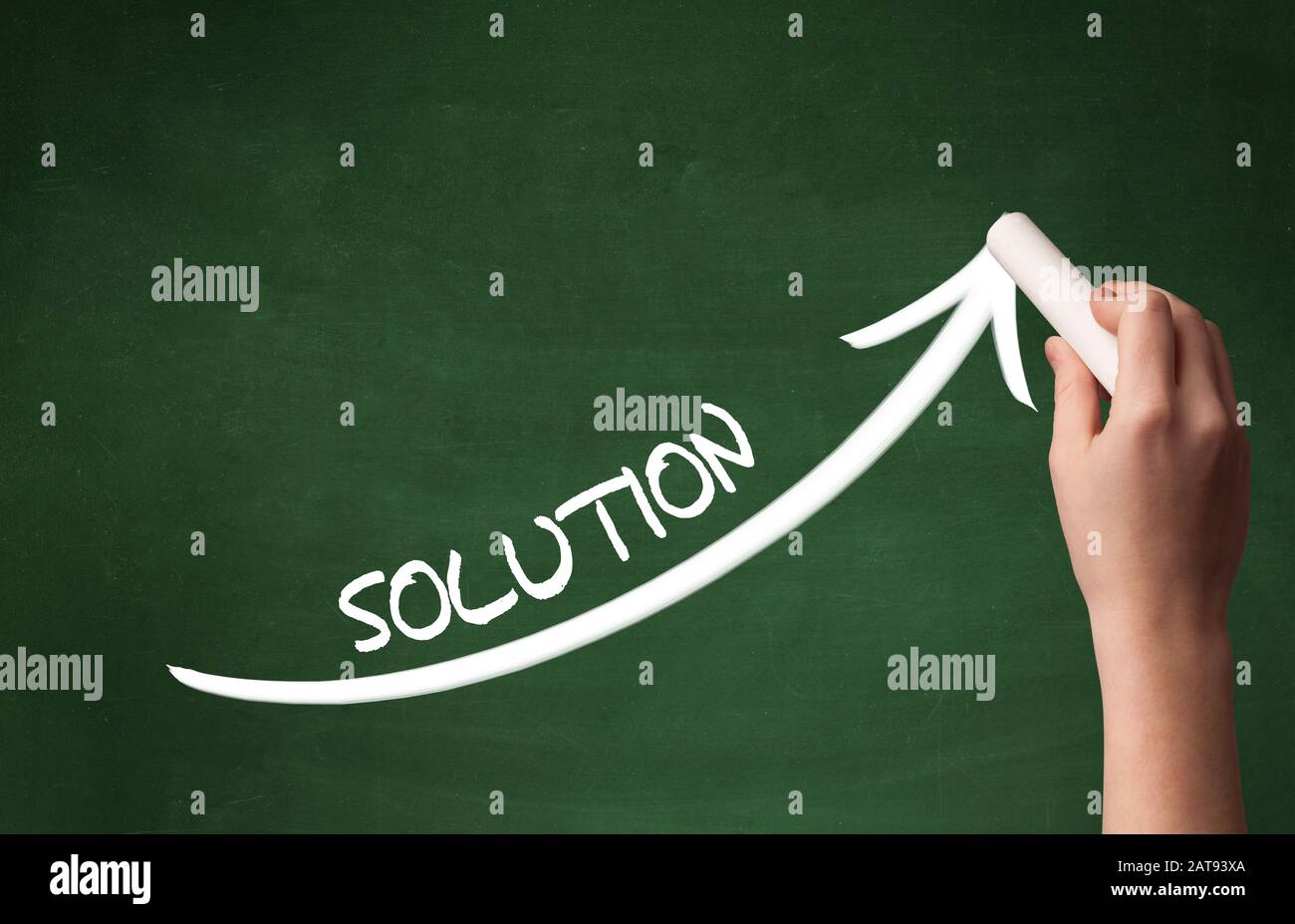 Hand drawing SOLUTION inscription with white chalk on blackboard ...