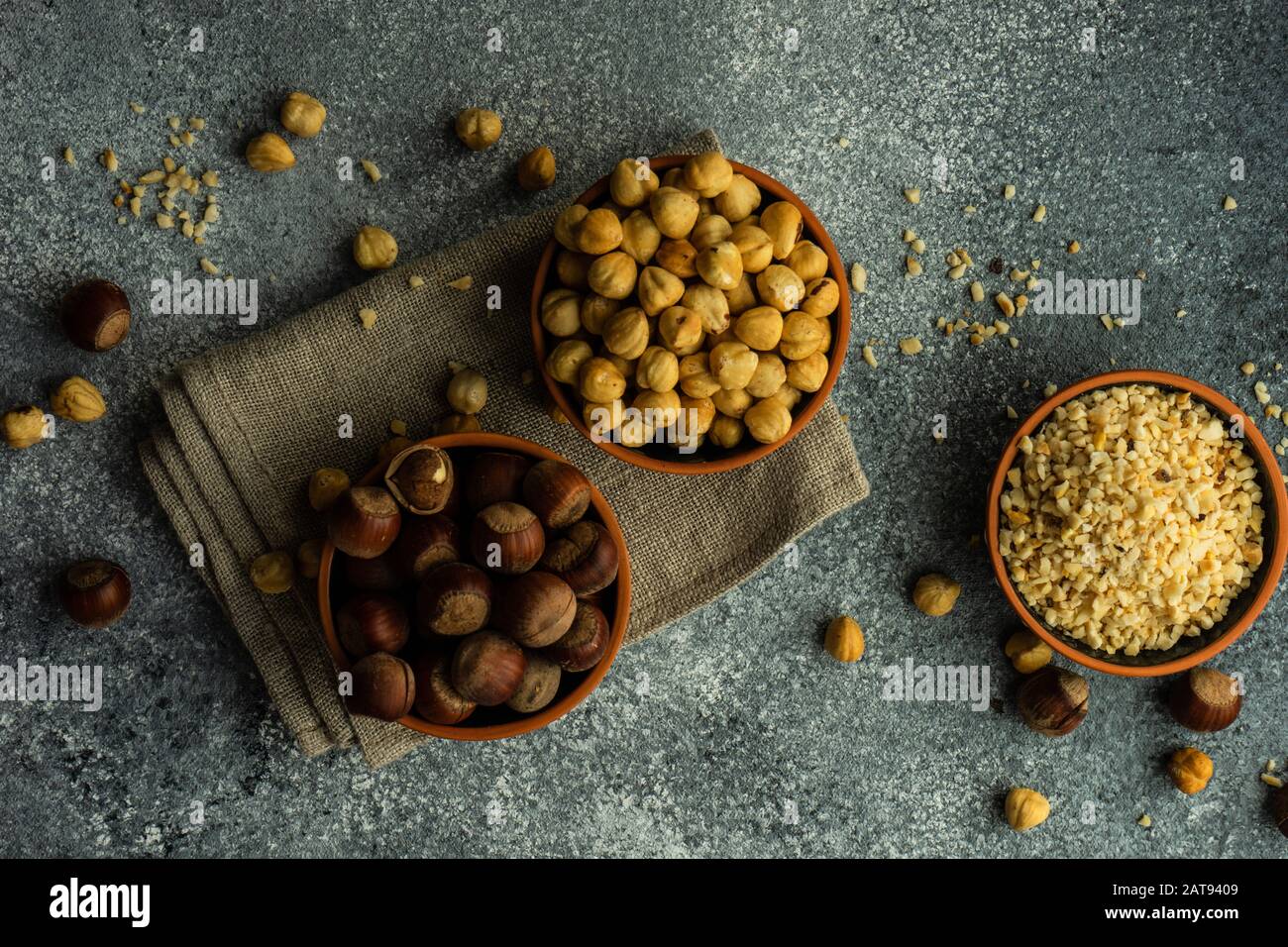 Different types of hazelnuts on dark wooden background with copyspace ...