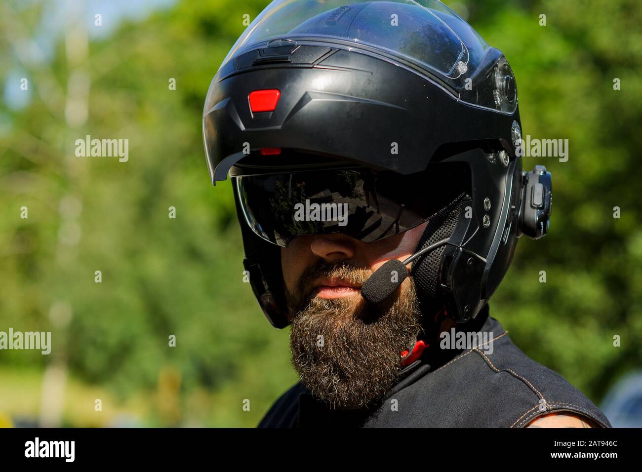 Man with a beard in a helmet. Opening of the motorcycle season. Biker ...