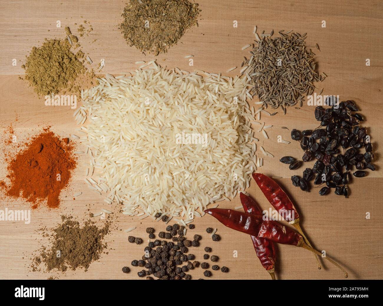 spices around rice for pilaf: zira, pepper, cordamon, hot chili peppers ...
