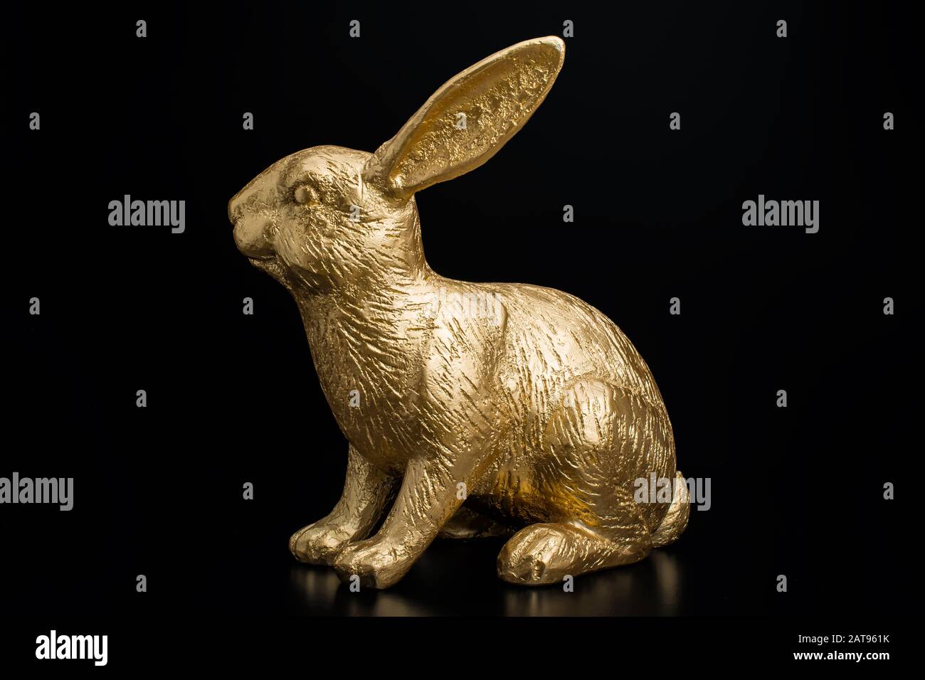 gold easter bunny rabbit on black background Stock Photo - Alamy