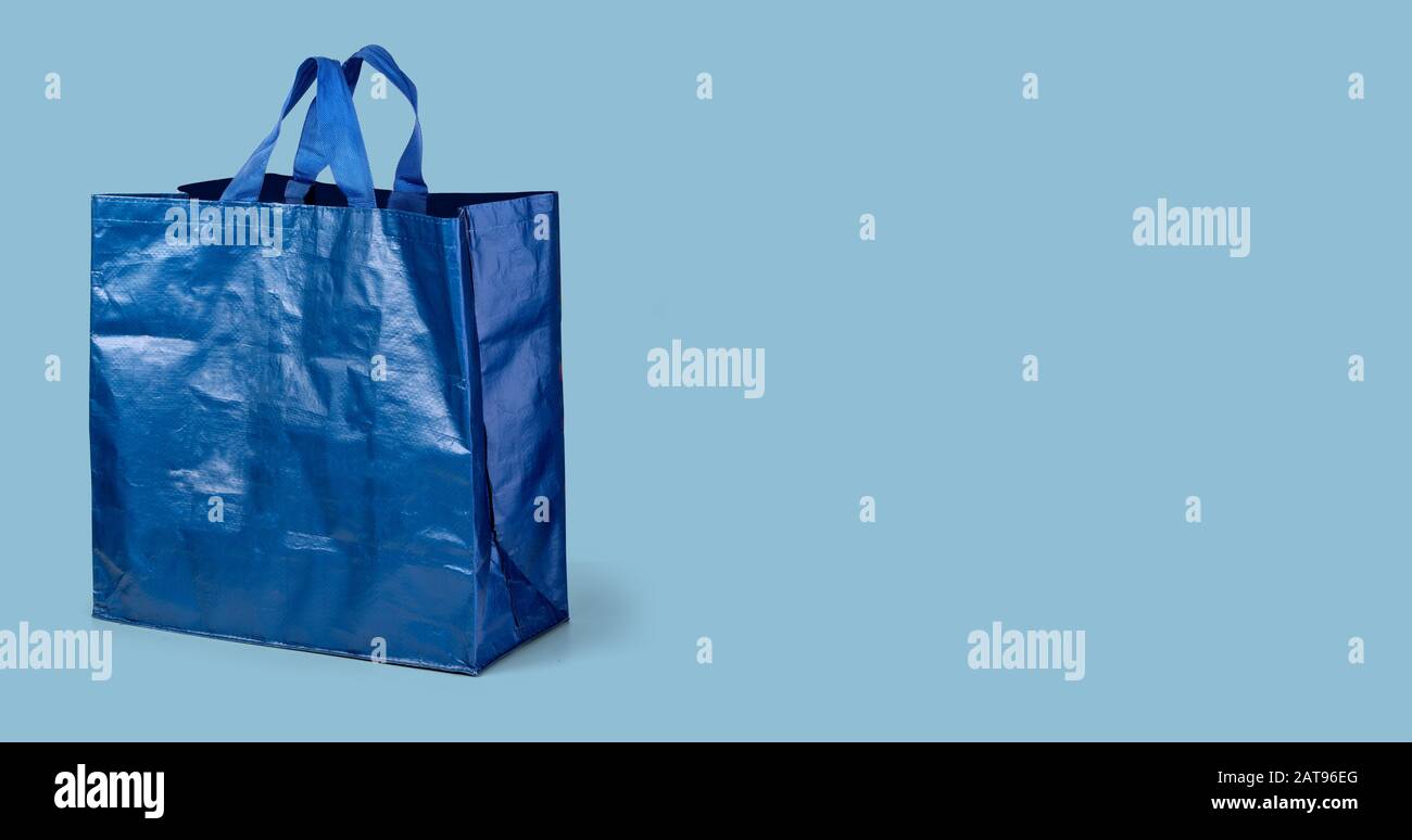 blue shopping bag isolated on light blue background with clipping path ...