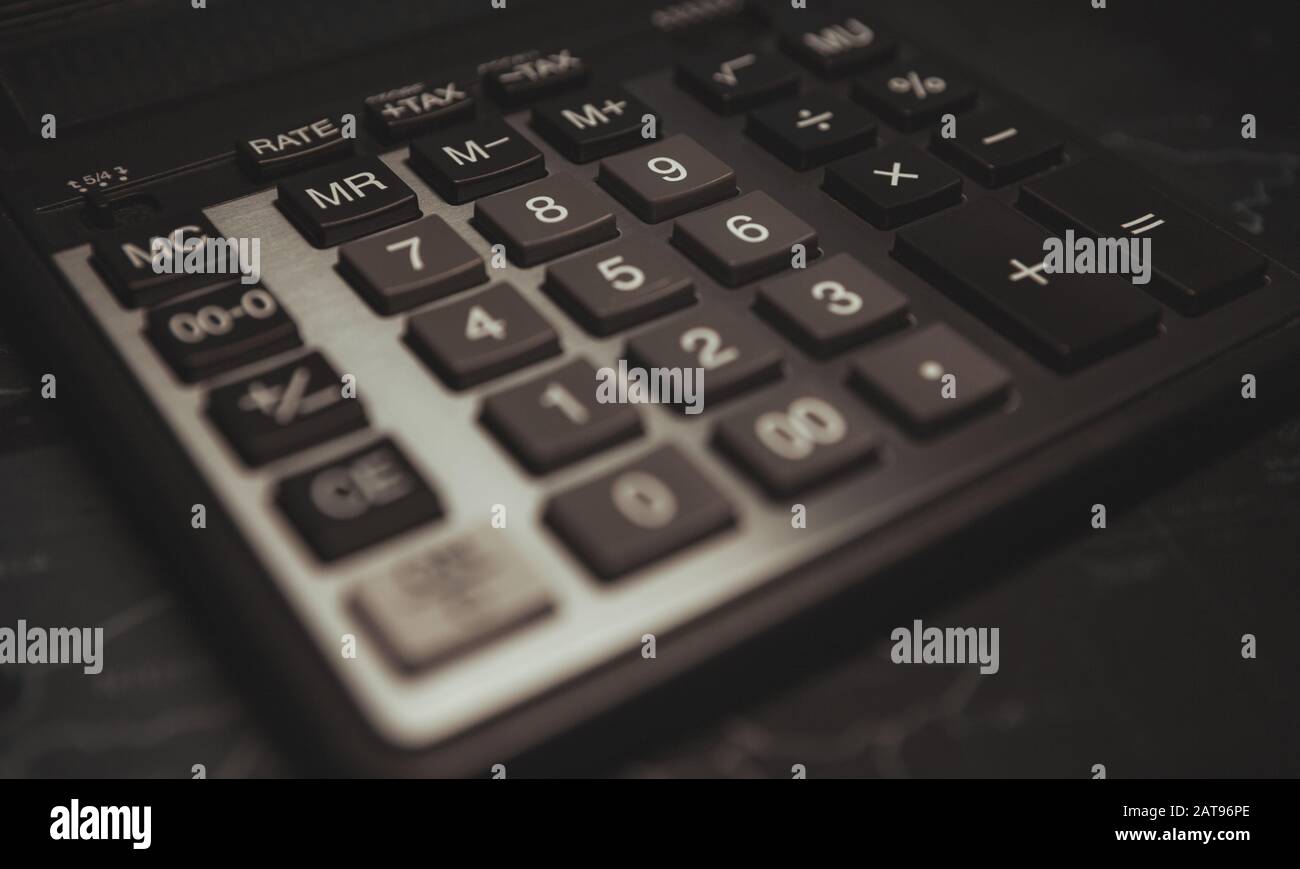 Calculator is placed on the desk in the office on dark background Stock ...