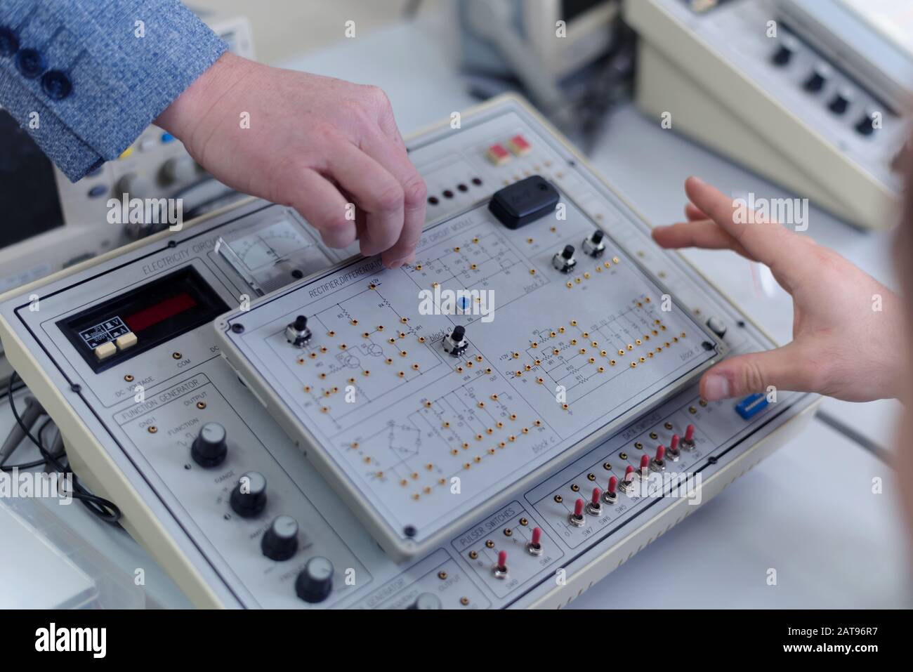 Engineering students working in the lab. Students are adjusting an ...