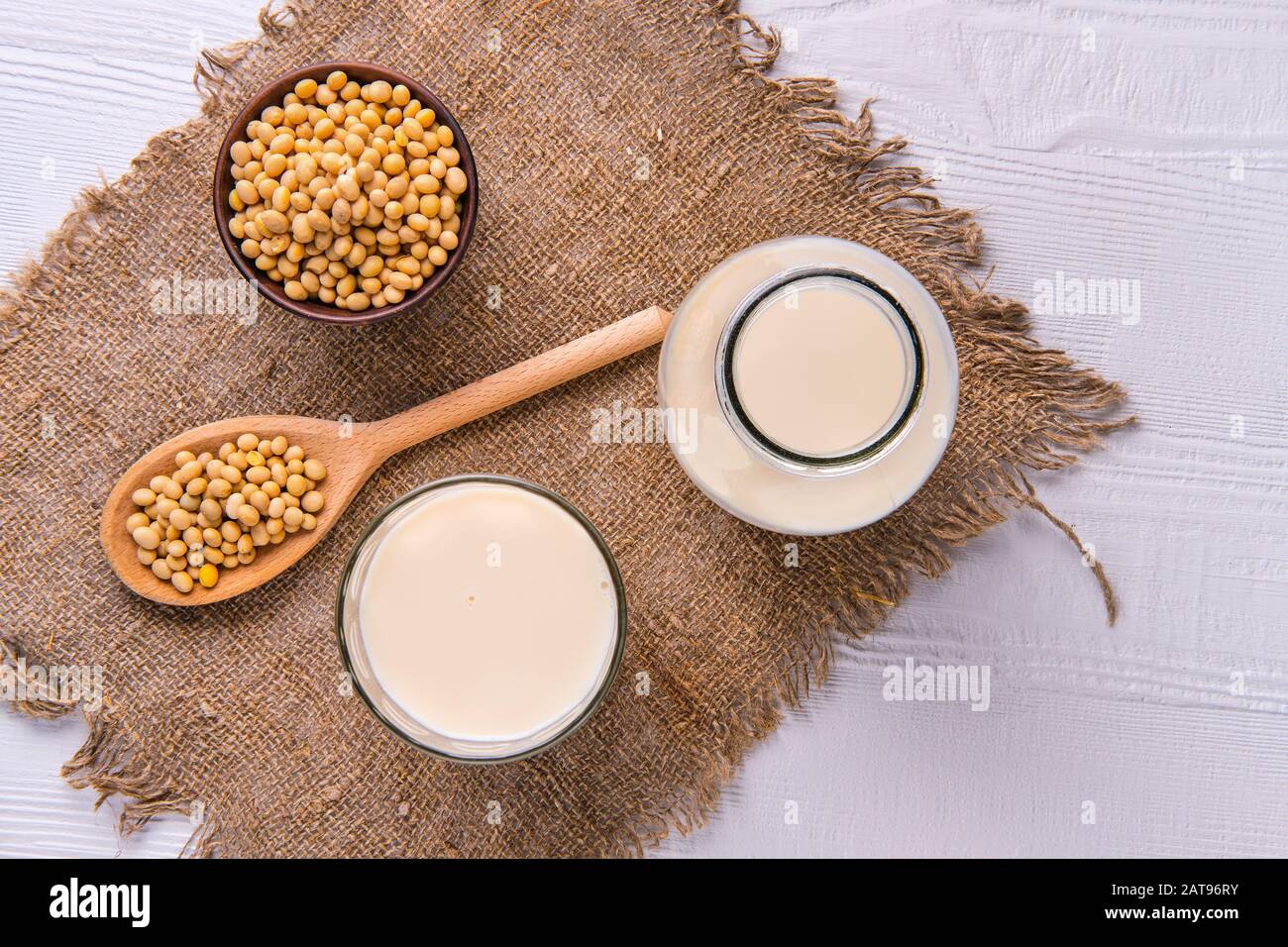 Top view of bottle of soy milk with soybeans on white table Stock Photo ...