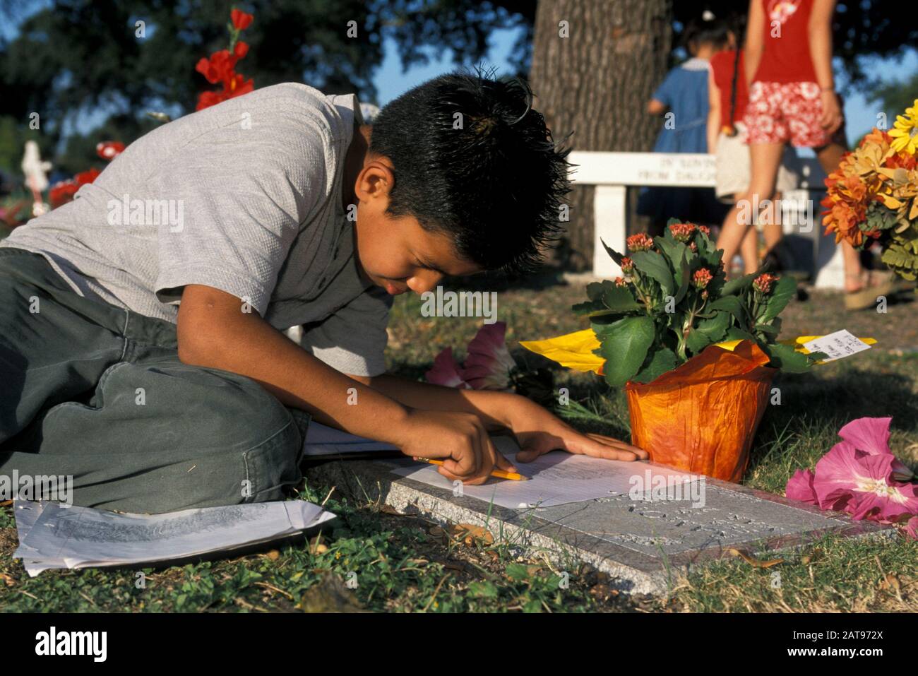 San Antonio, Texas: Hispanic child does gravestone rubbings at cemetery ...
