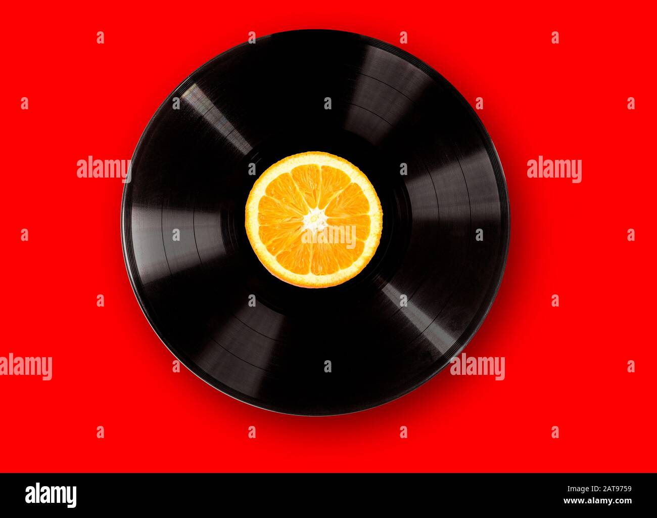 vinyl record on a bright red background. The concept of fresh music ...