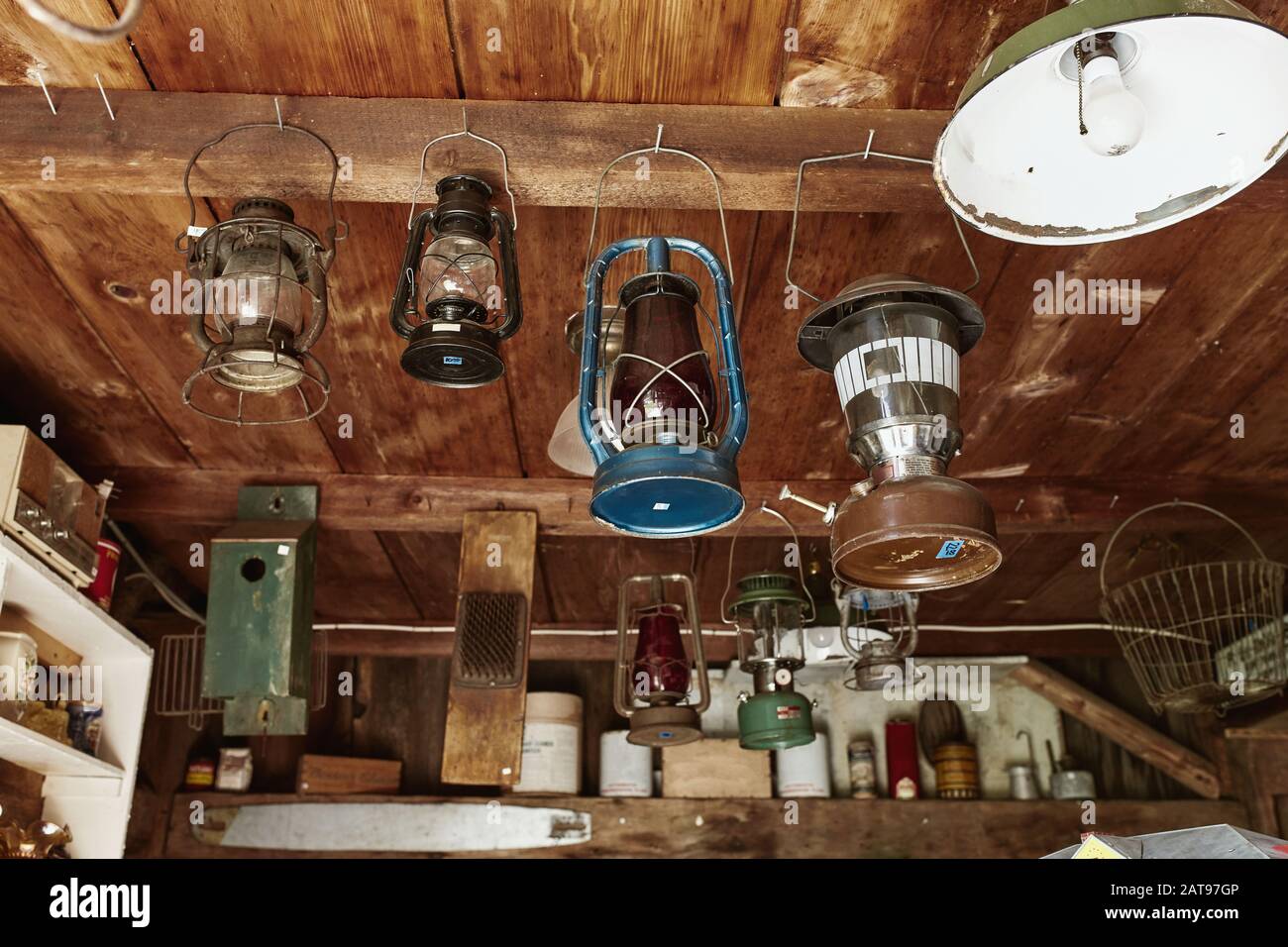 Vintage kerosene lanterns hanging from the ceiling of a wooden shack at ...